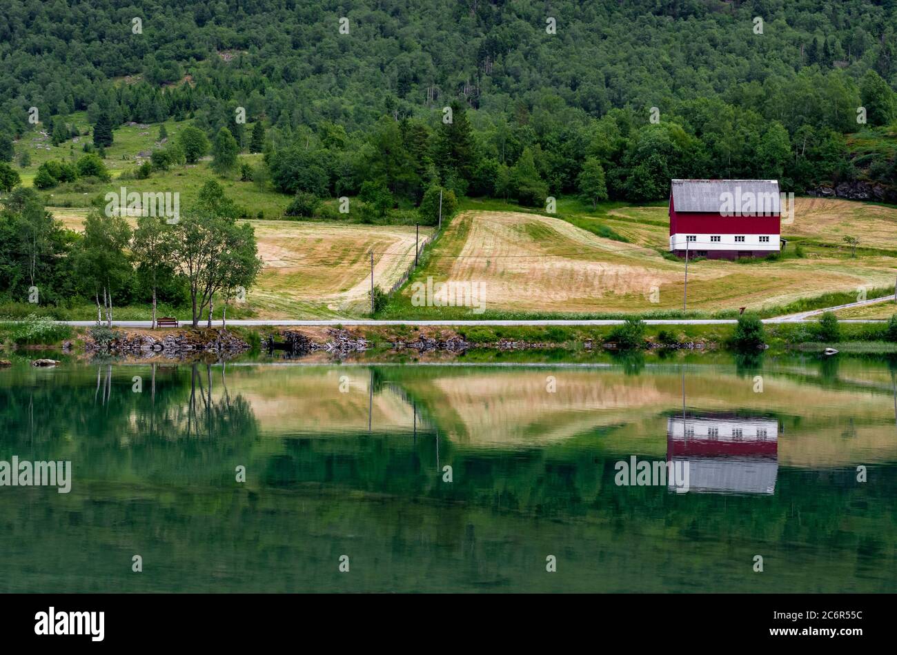 Beautiful Norwegian landscape reflected in the lake. Farm houses ...