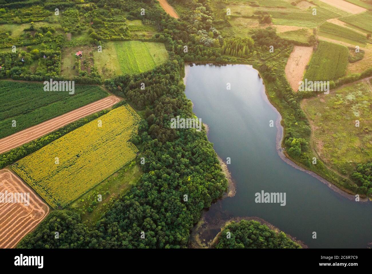 Small lake between agricultural fields aerial view Stock Photo - Alamy