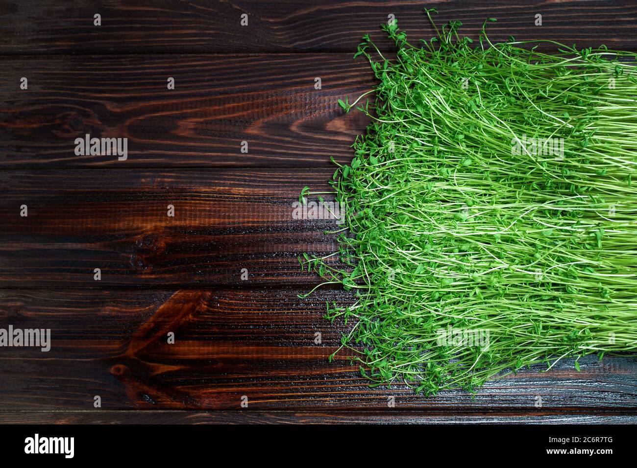 Clover sprouts on wood table background top view. Sprouted vegetable ...