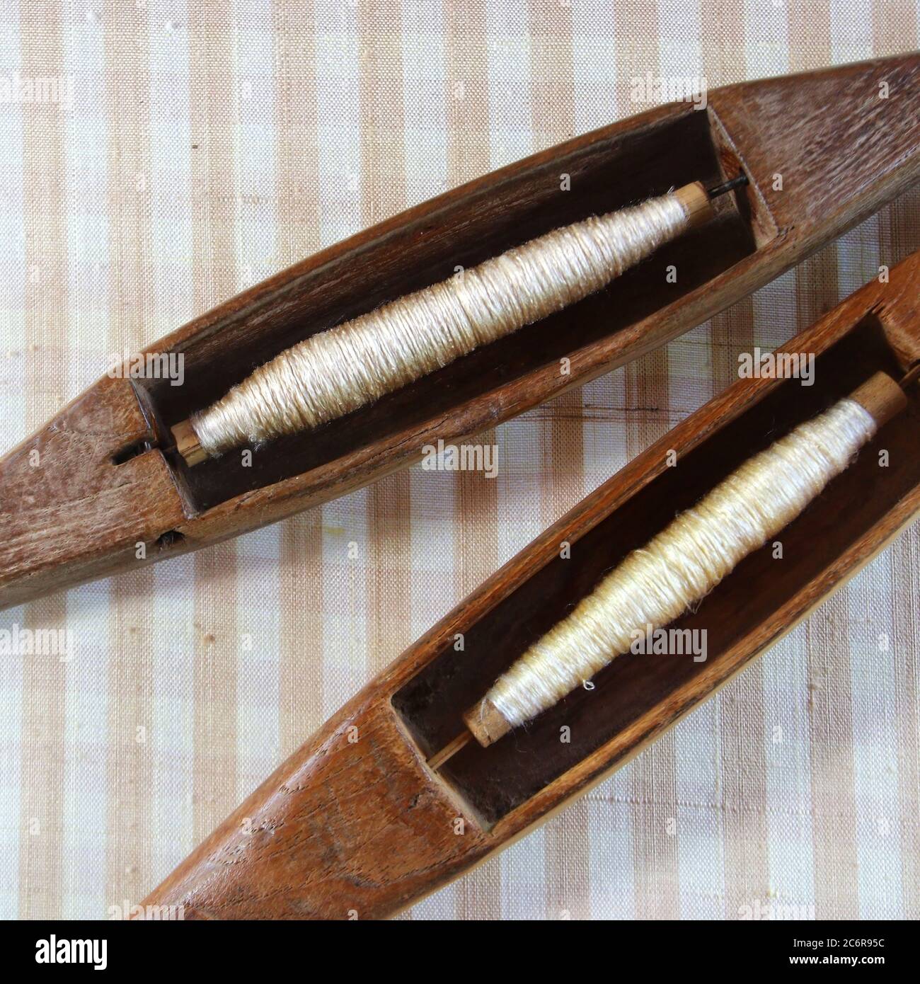 wooden bobbin on silk fabric, traditional weaving of Thai silk Stock ...