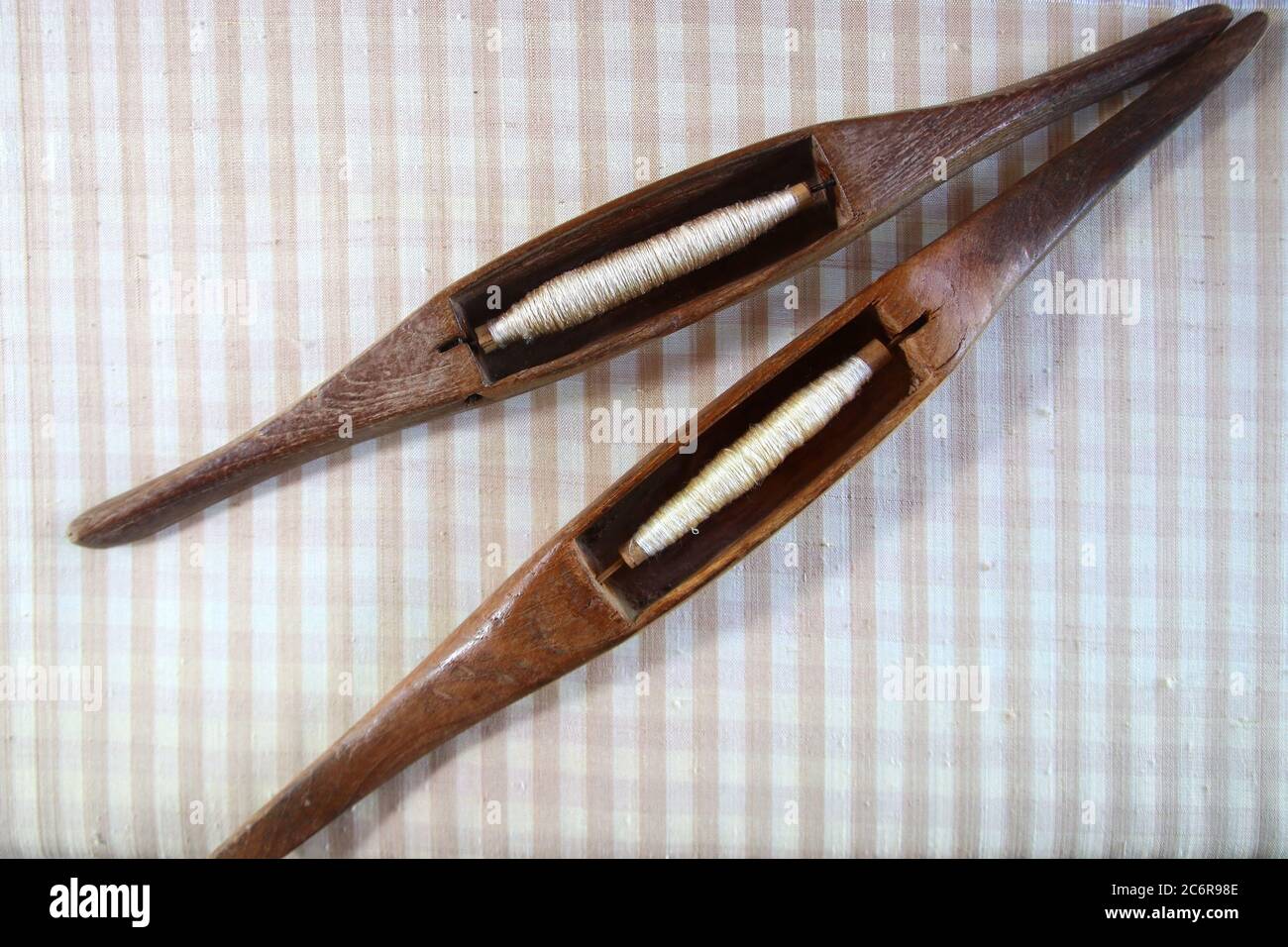 wooden bobbin on silk fabric, traditional weaving of Thai silk Stock ...