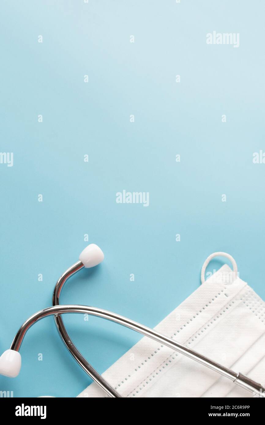 Composition with medical stethoscope, disposable face masks on a blue ...