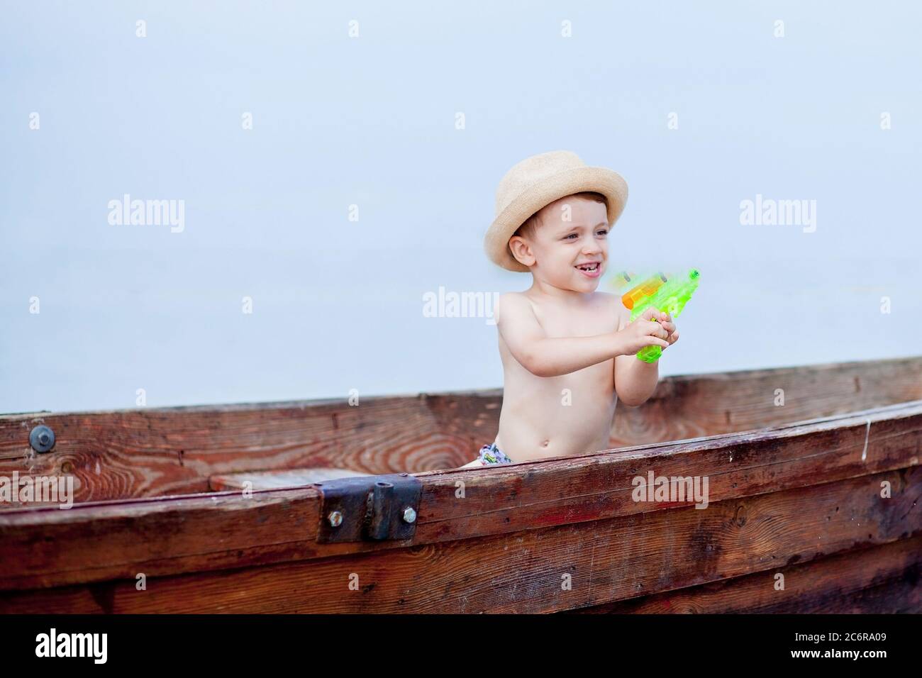 Little boy is resting in a boat on the lake Stock Photo - Alamy