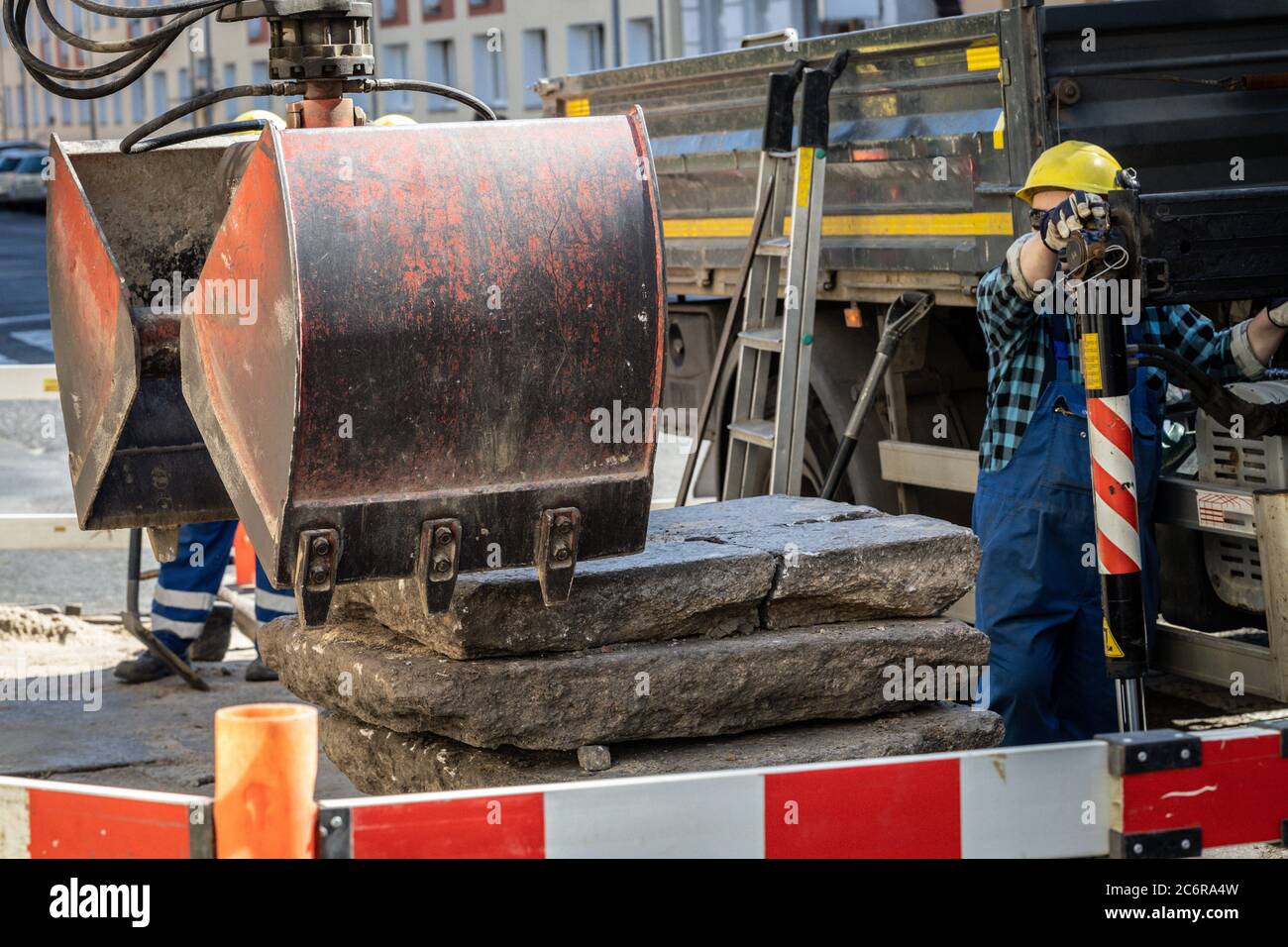 Construction works on the road. Excavator for smaller municipal works ...