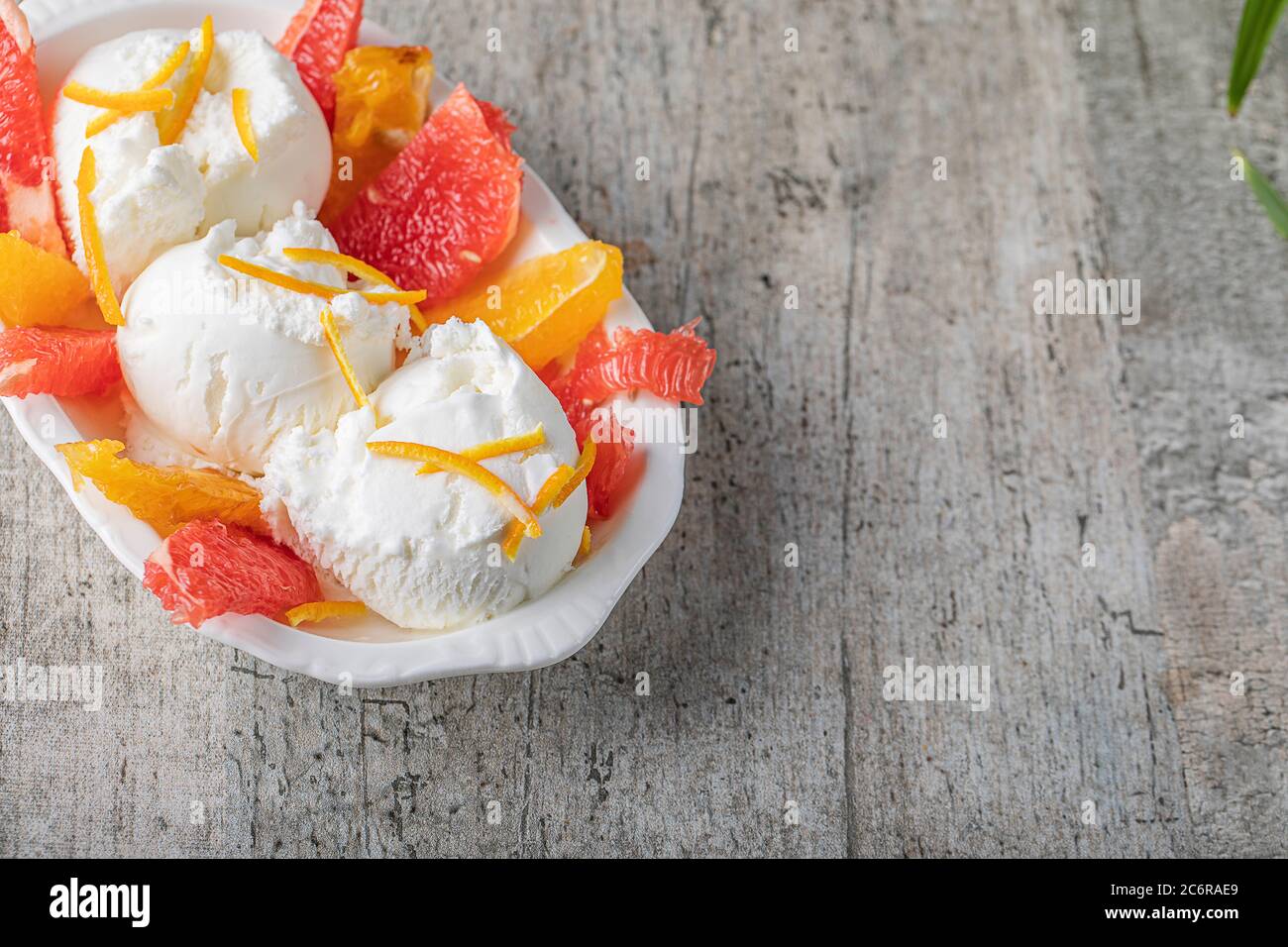 Vanilla icecream balls with orange and grapefruit Stock Photo - Alamy