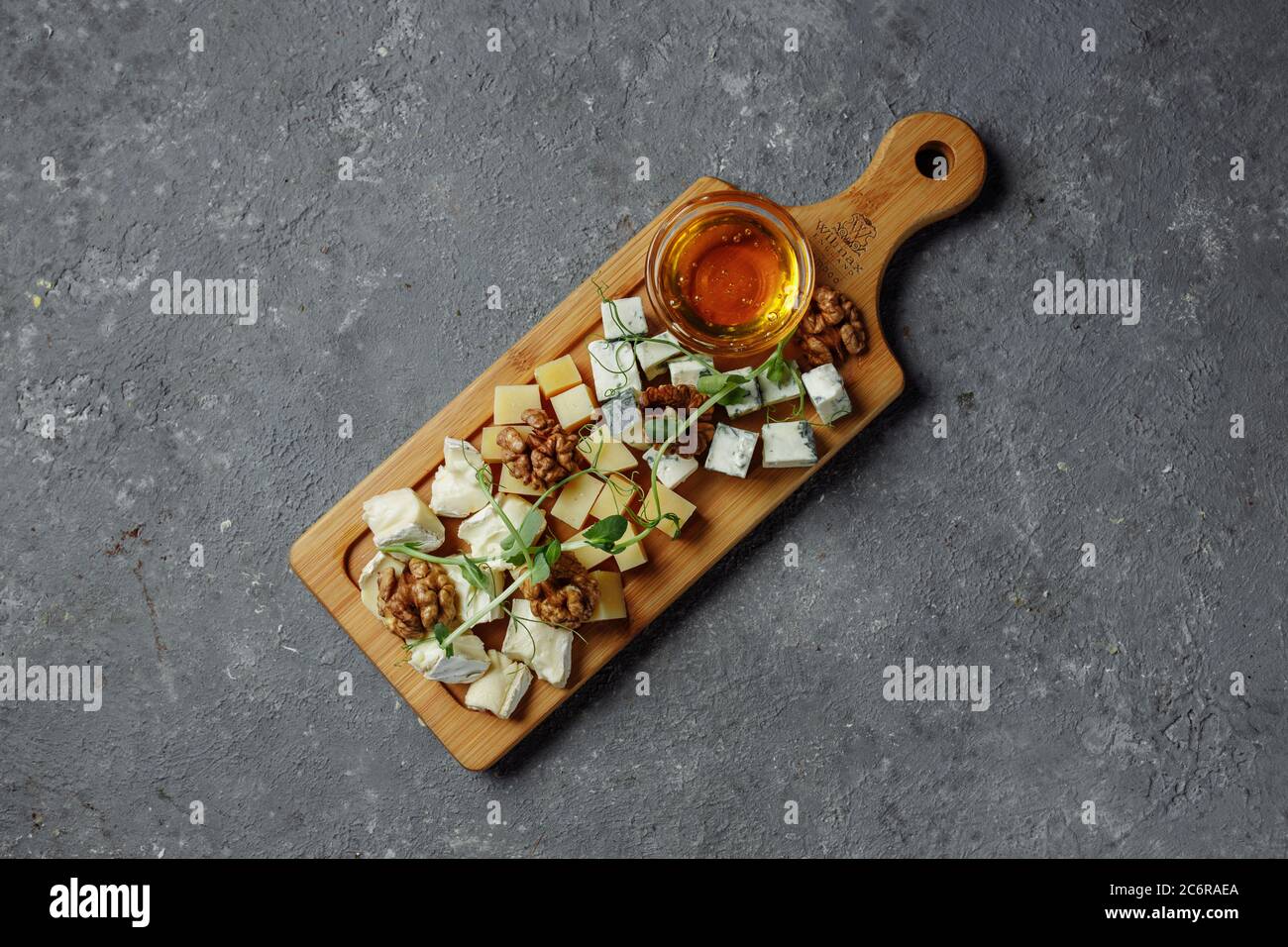 Close-up of a cheese plate. 4 types of cheese, soft white brie cheese ...
