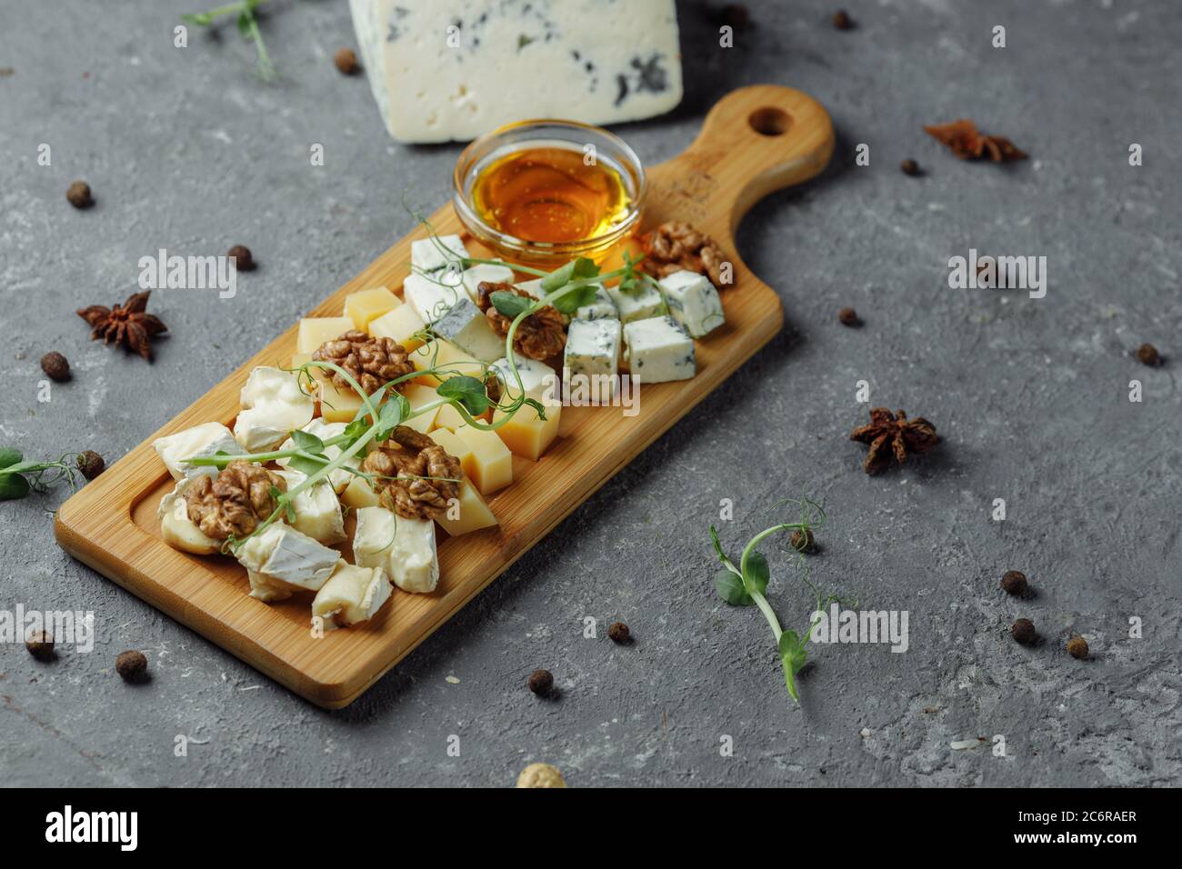 Close-up of a cheese plate. 4 types of cheese, soft white brie cheese ...
