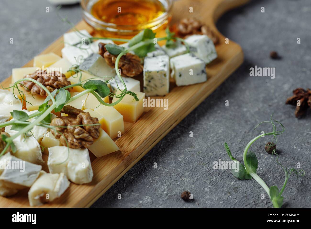 Close-up of a cheese plate. 4 types of cheese, soft white brie cheese ...