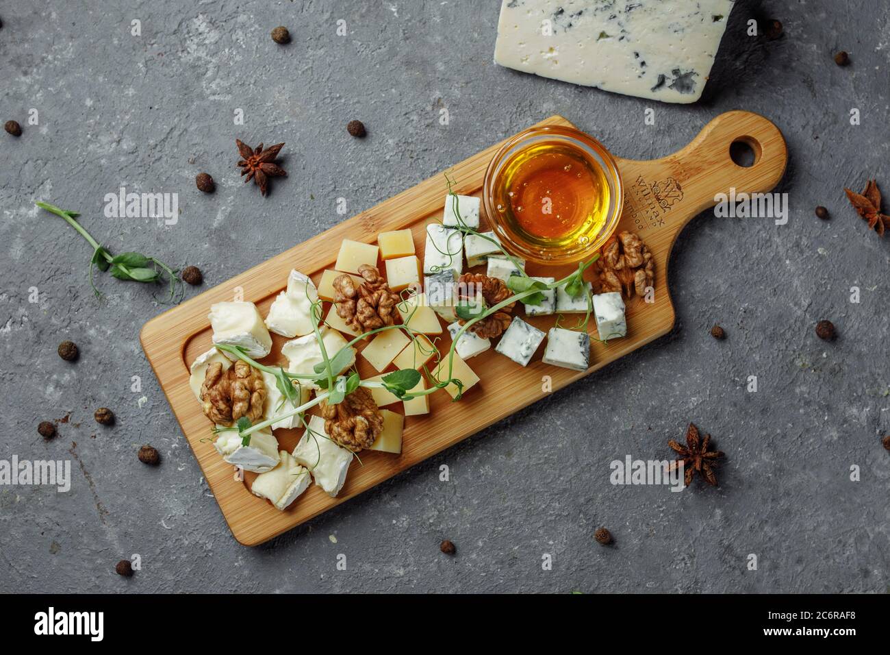 Close-up of a cheese plate. 4 types of cheese, soft white brie cheese ...