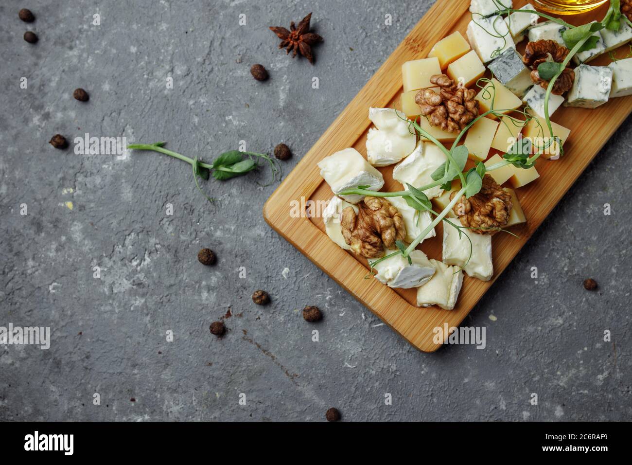 Close-up of a cheese plate. 4 types of cheese, soft white brie cheese ...