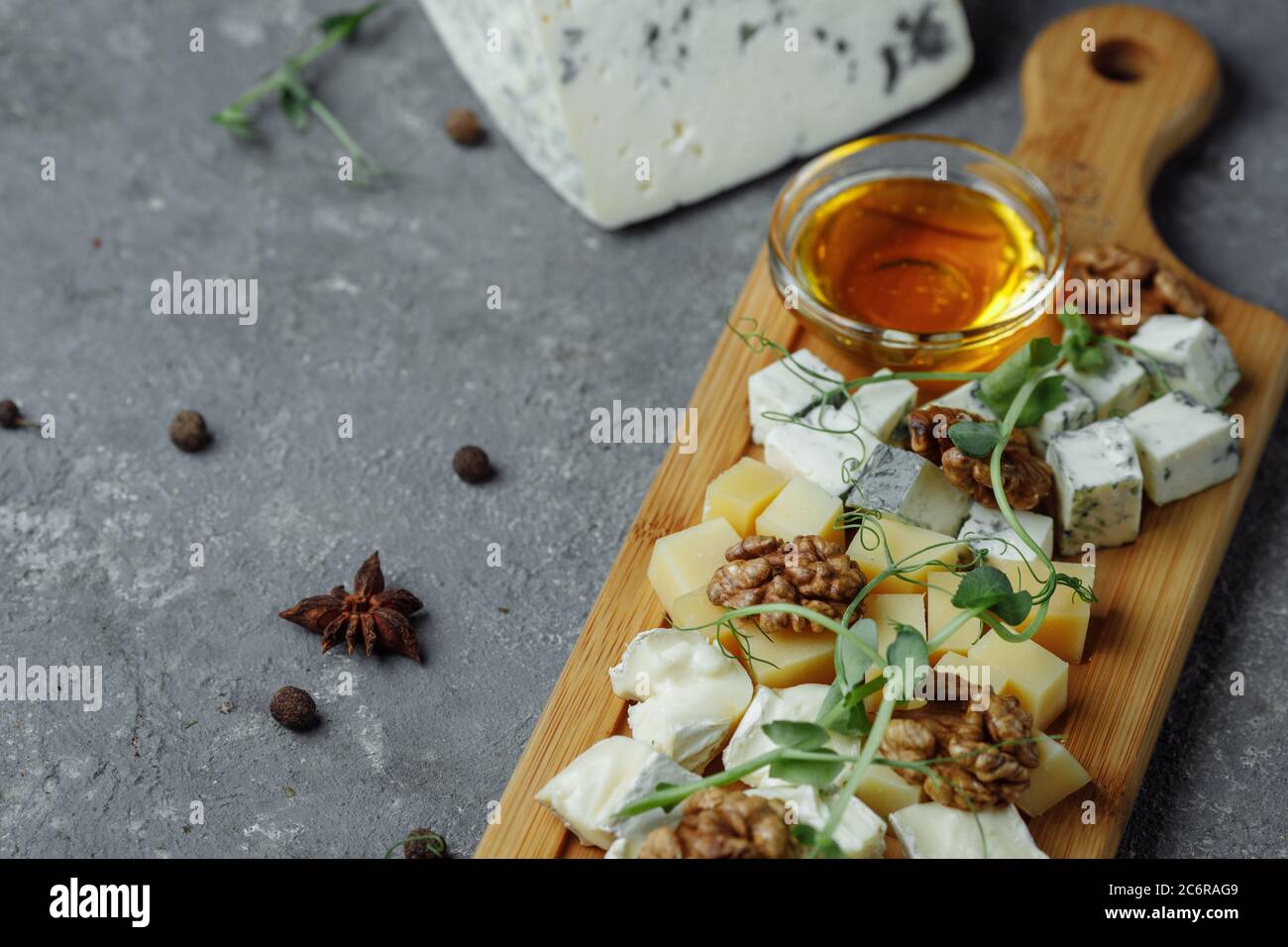 Close-up of a cheese plate. 4 types of cheese, soft white brie cheese ...