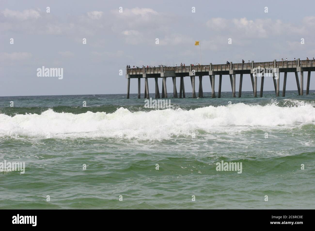 Powerful surf at beach in Pensacola Florida with pier in background ...
