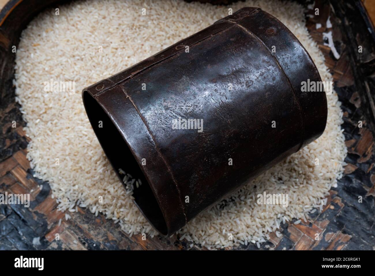 Indian rice/grains measuring iron equipment isolated on rice background ...