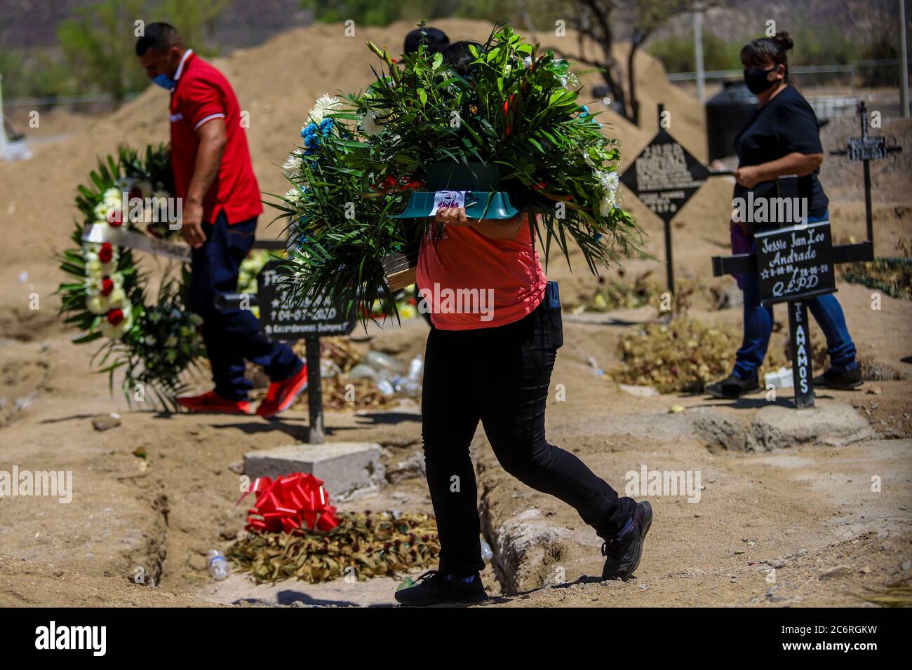 HERMOSILLO, MEXICO - JULY 11:Family and friends of a deceased walk with ...