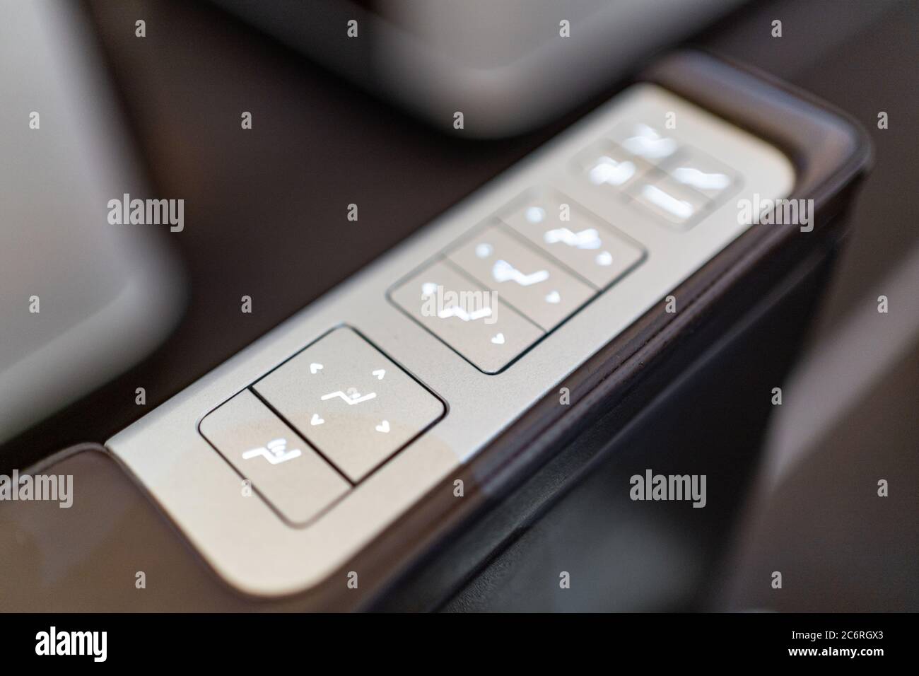 Close up of the business class seat control buttons on an airplane ...