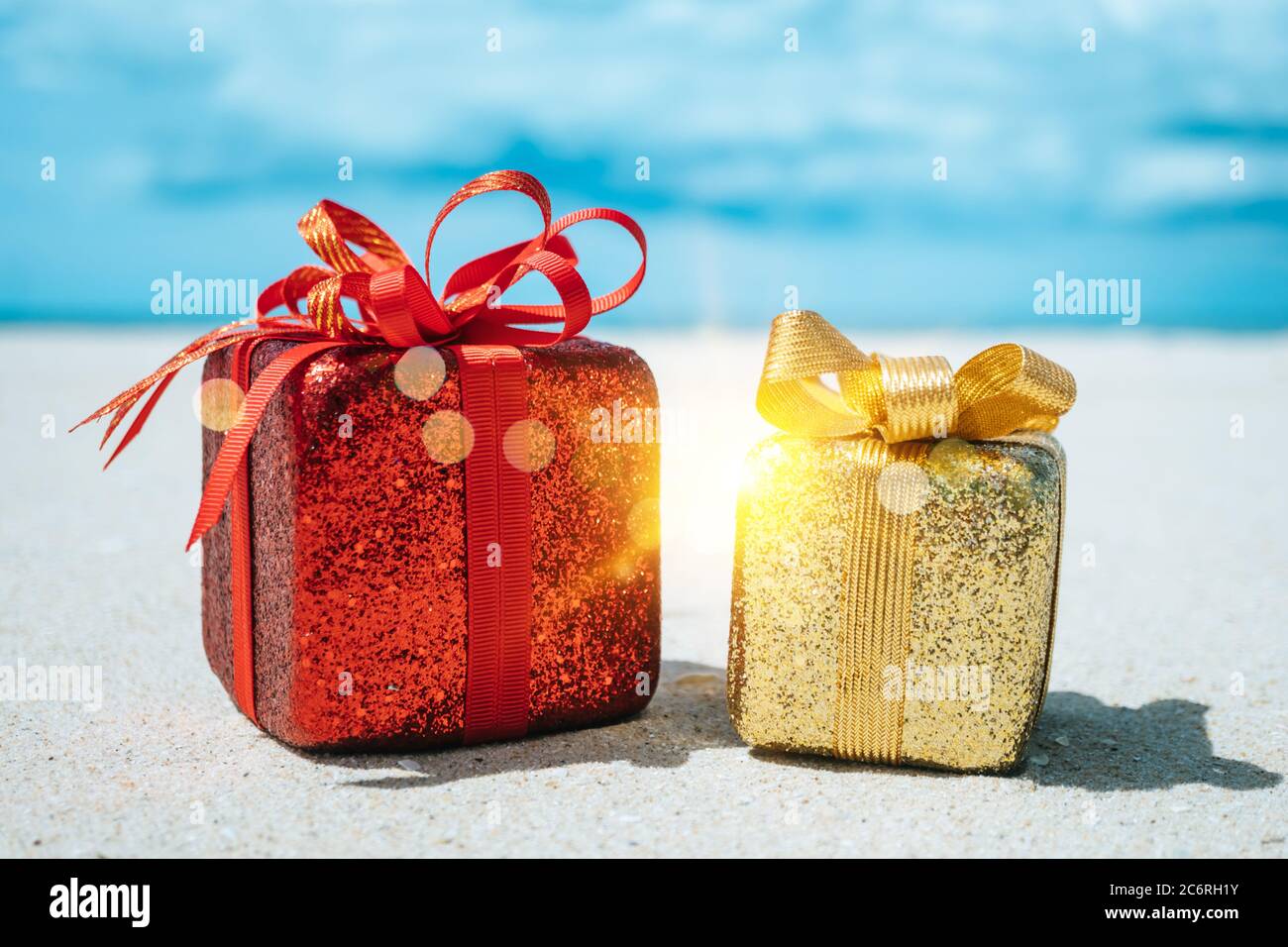 Gift boxes on sandy beach. Hot tours or holiday vacation concept with ...