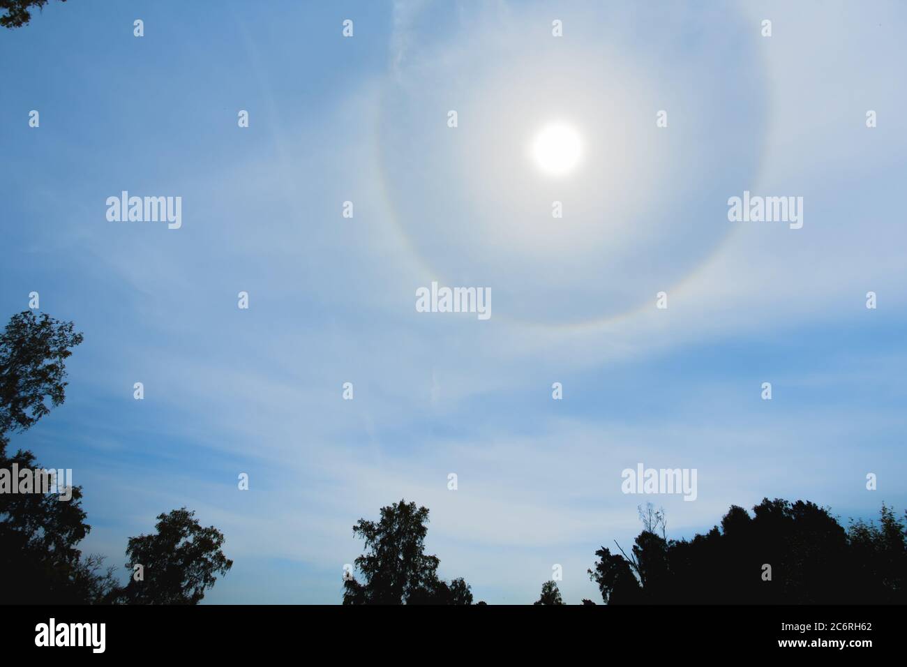 Atmospheric optical effect circle around the sun on hot summer day ...