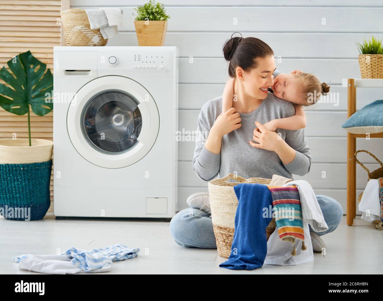 Beautiful young woman and child girl little helper are having fun and ...