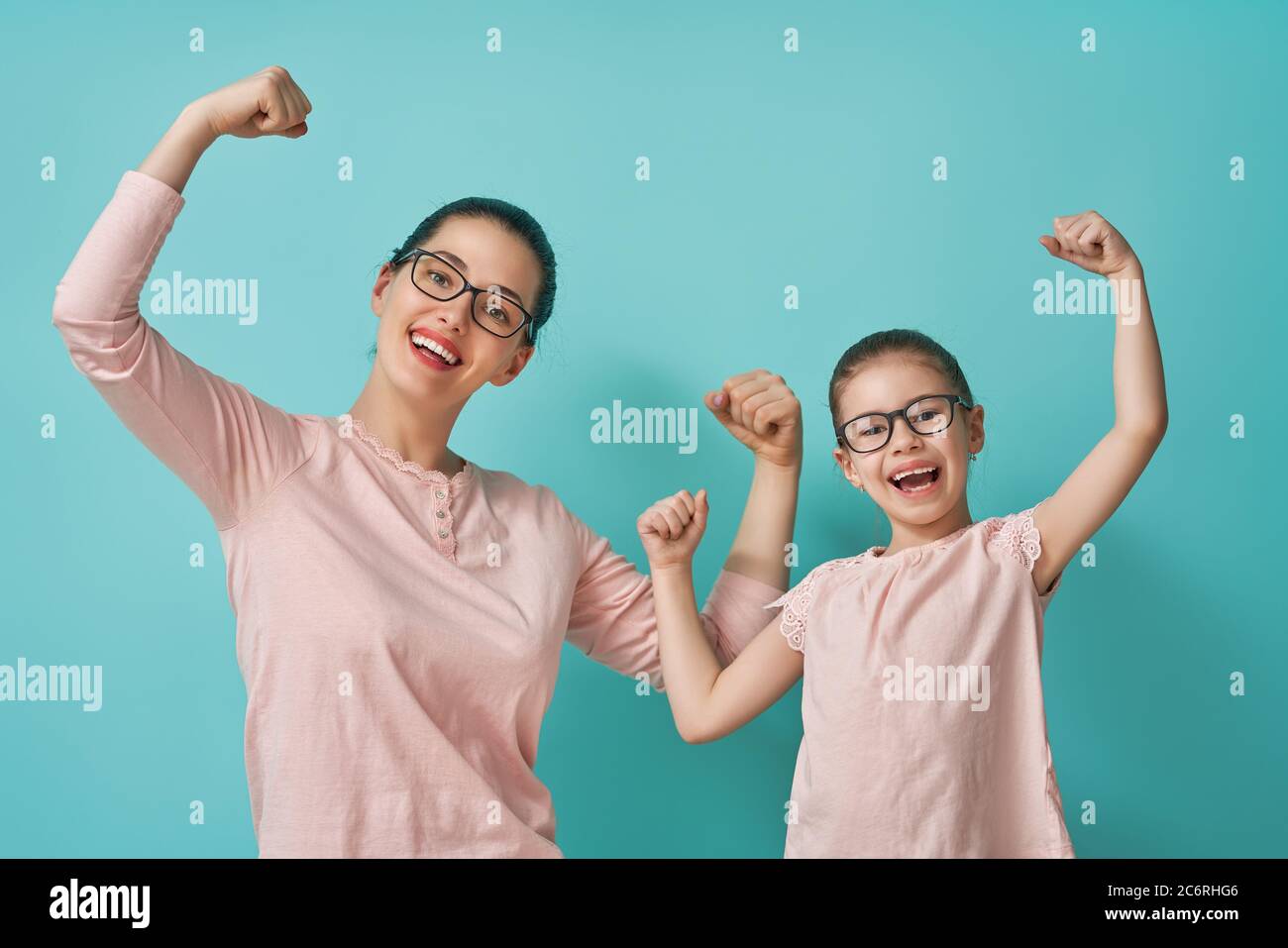 Funny family on a background of bright blue wall. Mother and her ...