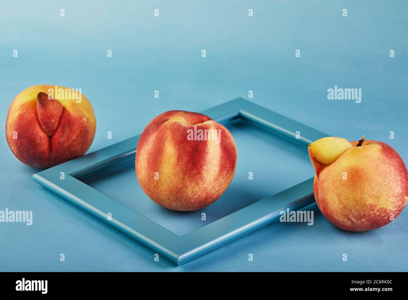 An ugly fruit or vegetable. Concept Fresh peach in a frame and two Very ...