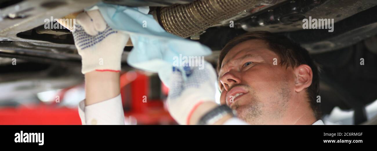 Serious male worker busy with repairing Stock Photo - Alamy