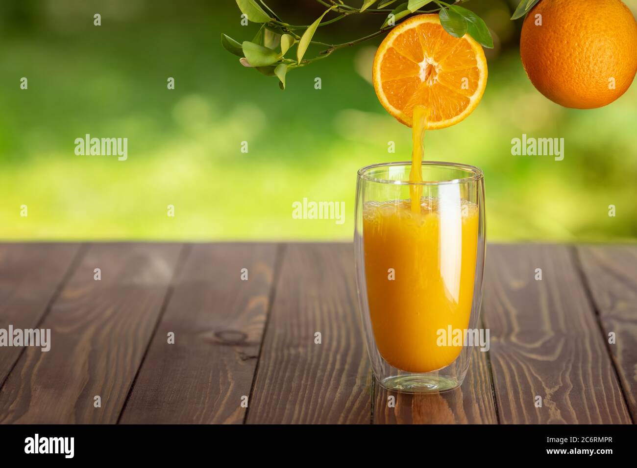 orange juice pouring into glass Stock Photo - Alamy