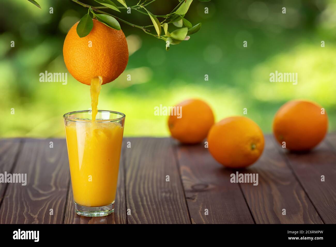 orange juice pouring into glass Stock Photo - Alamy