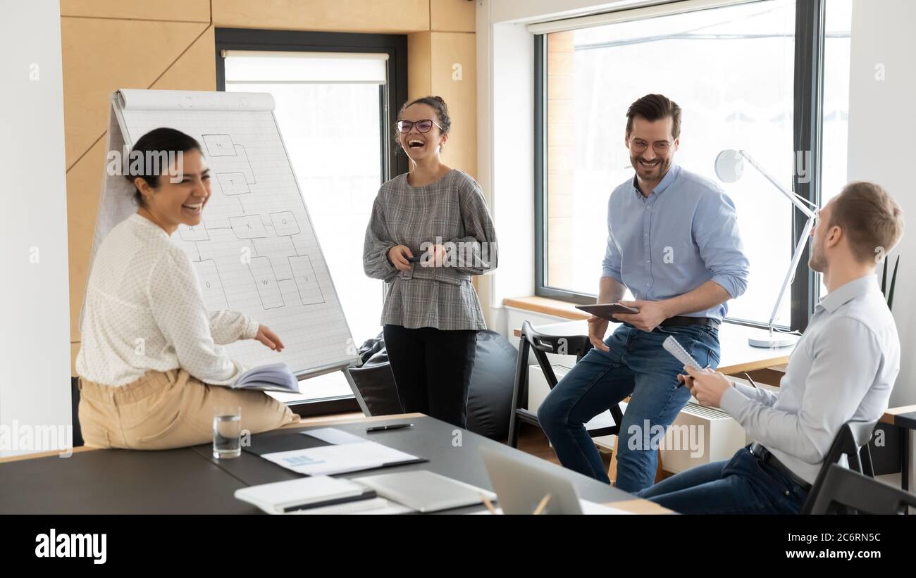Smiling diverse employees have fun at group presentation meeting Stock ...