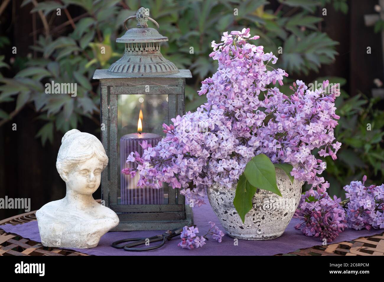 spring garden decoration with bouquet of lilac and lantern Stock Photo ...