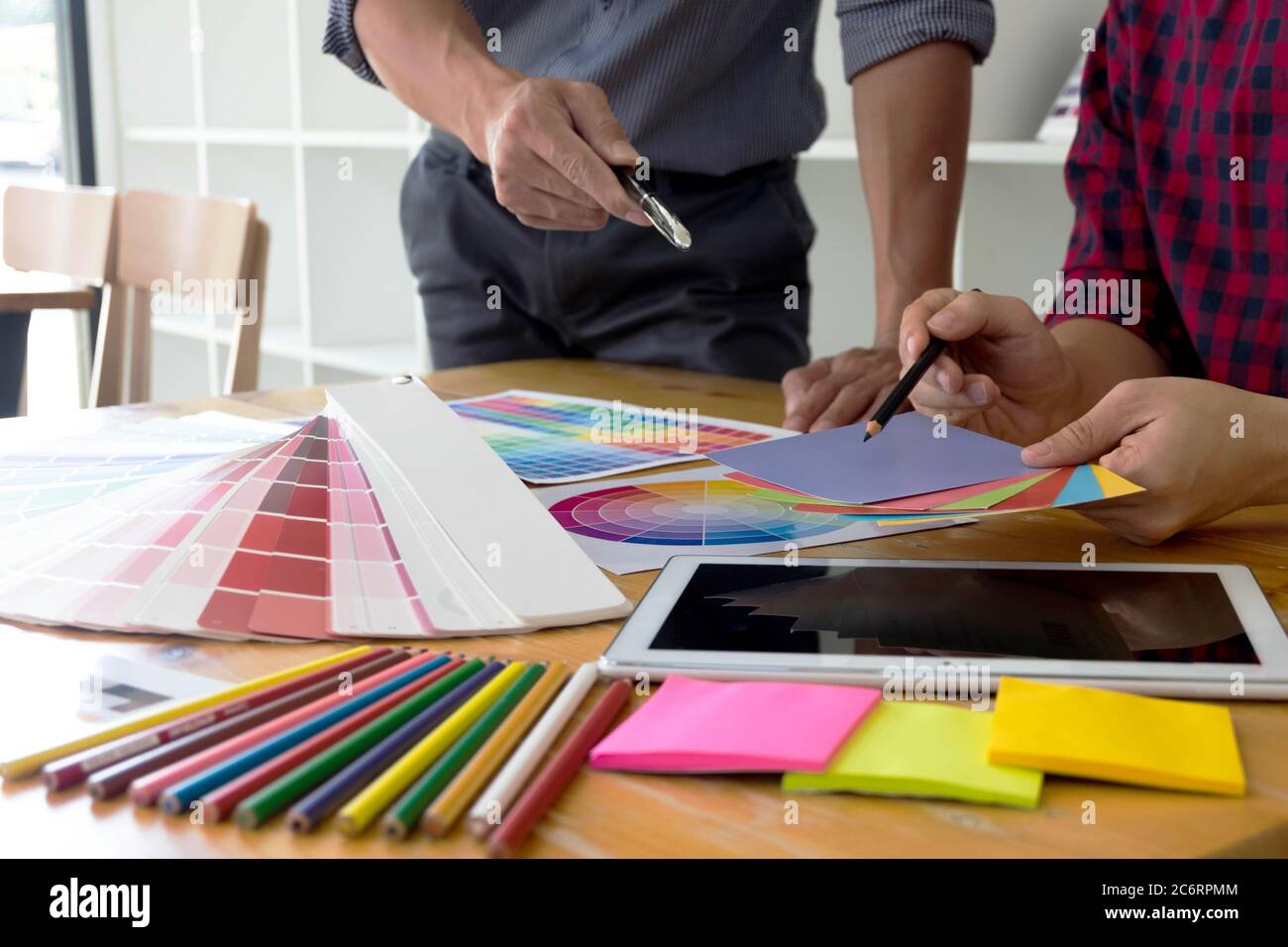 Graphic designers present colors from the color palette to their ...