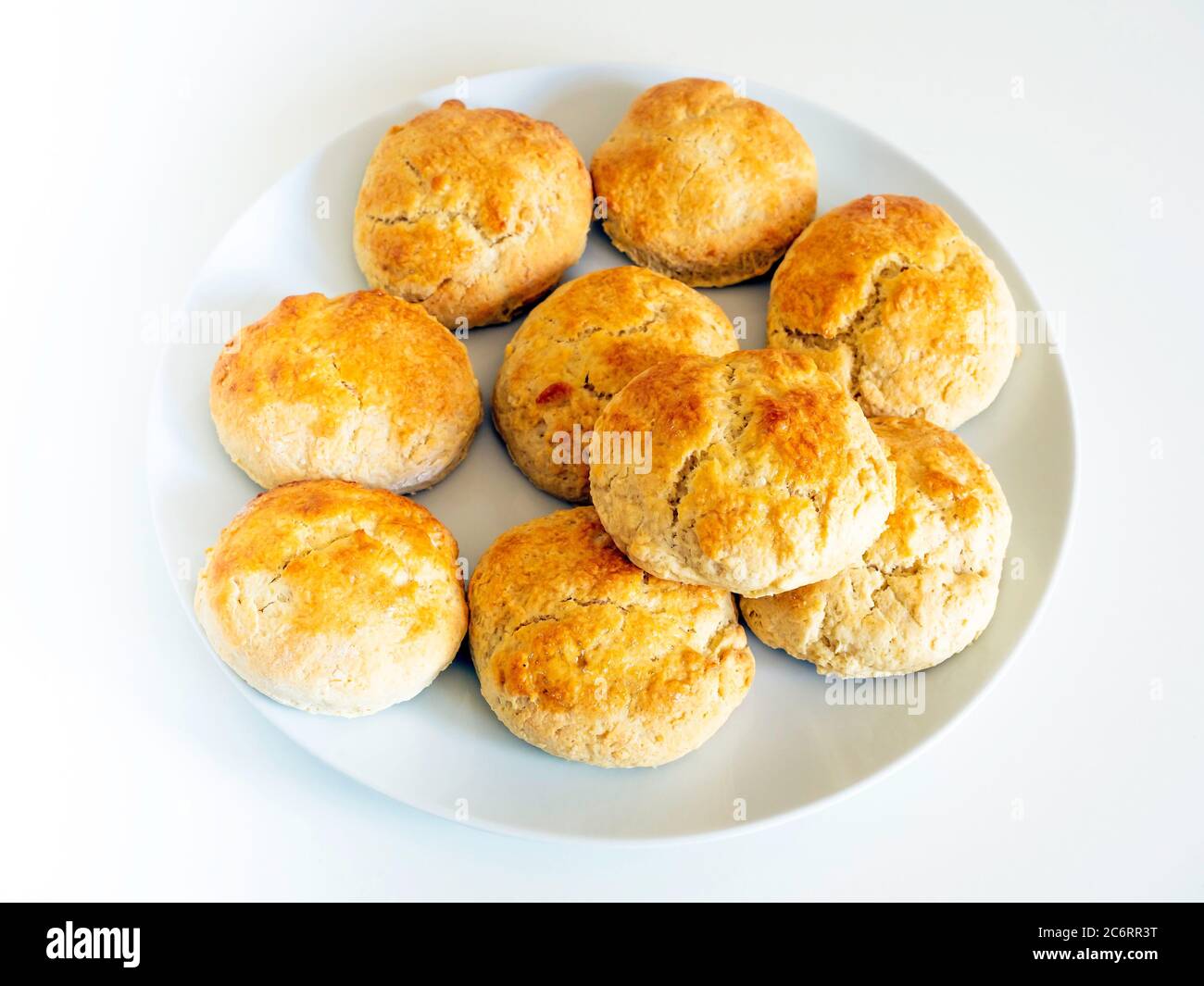 Freshly baked traditional British scones on a white plate on a white ...
