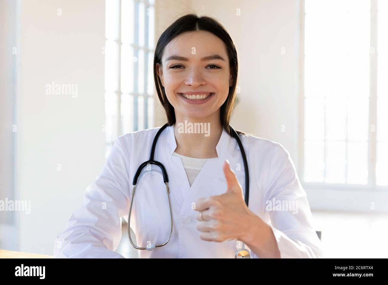 Head shot portrait smiling female doctor showing thumb up Stock Photo ...