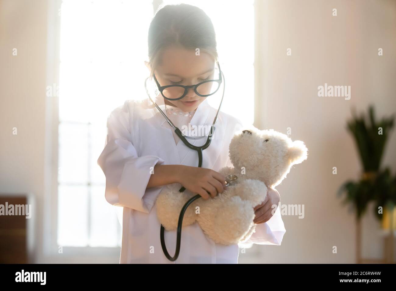 Close up pretty little girl playing doctor, using stethoscope Stock ...