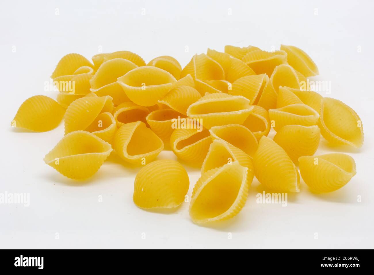 Dried conchiglie pasta against a white background Stock Photo - Alamy