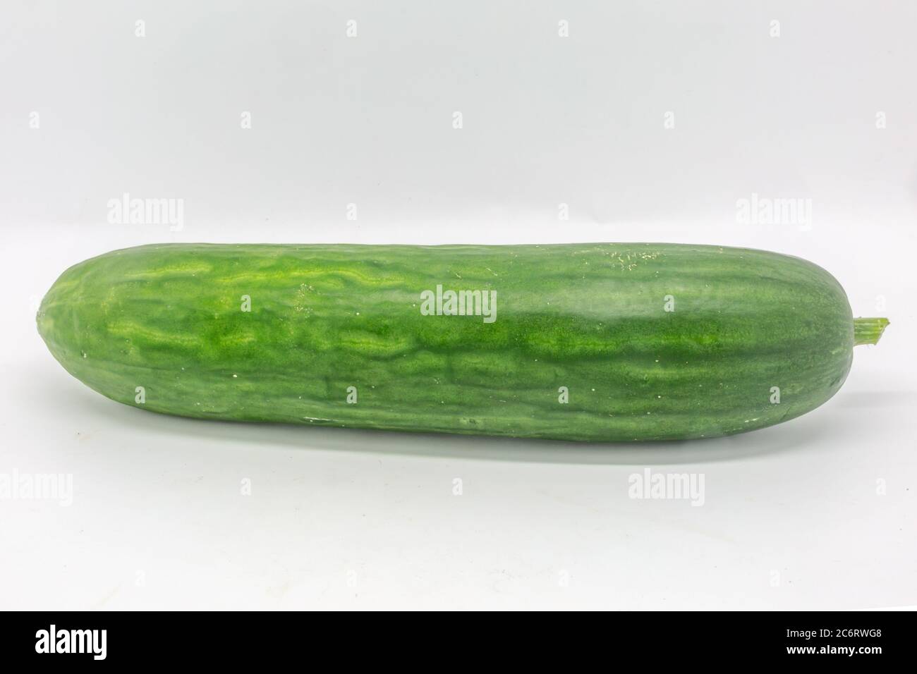 A whole cucumber against a white background Stock Photo - Alamy