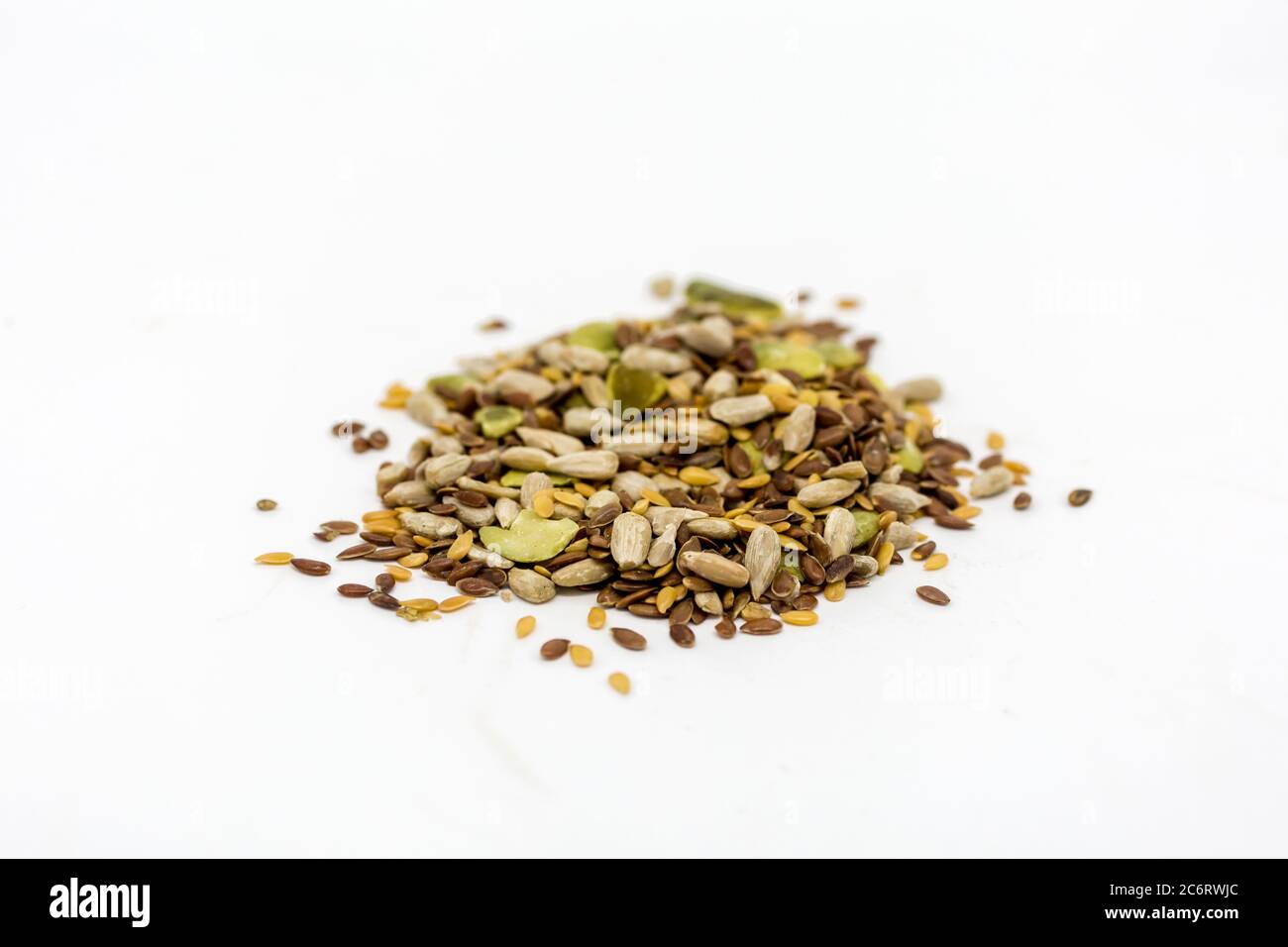 A pile of mixed seeds against a white background Stock Photo - Alamy