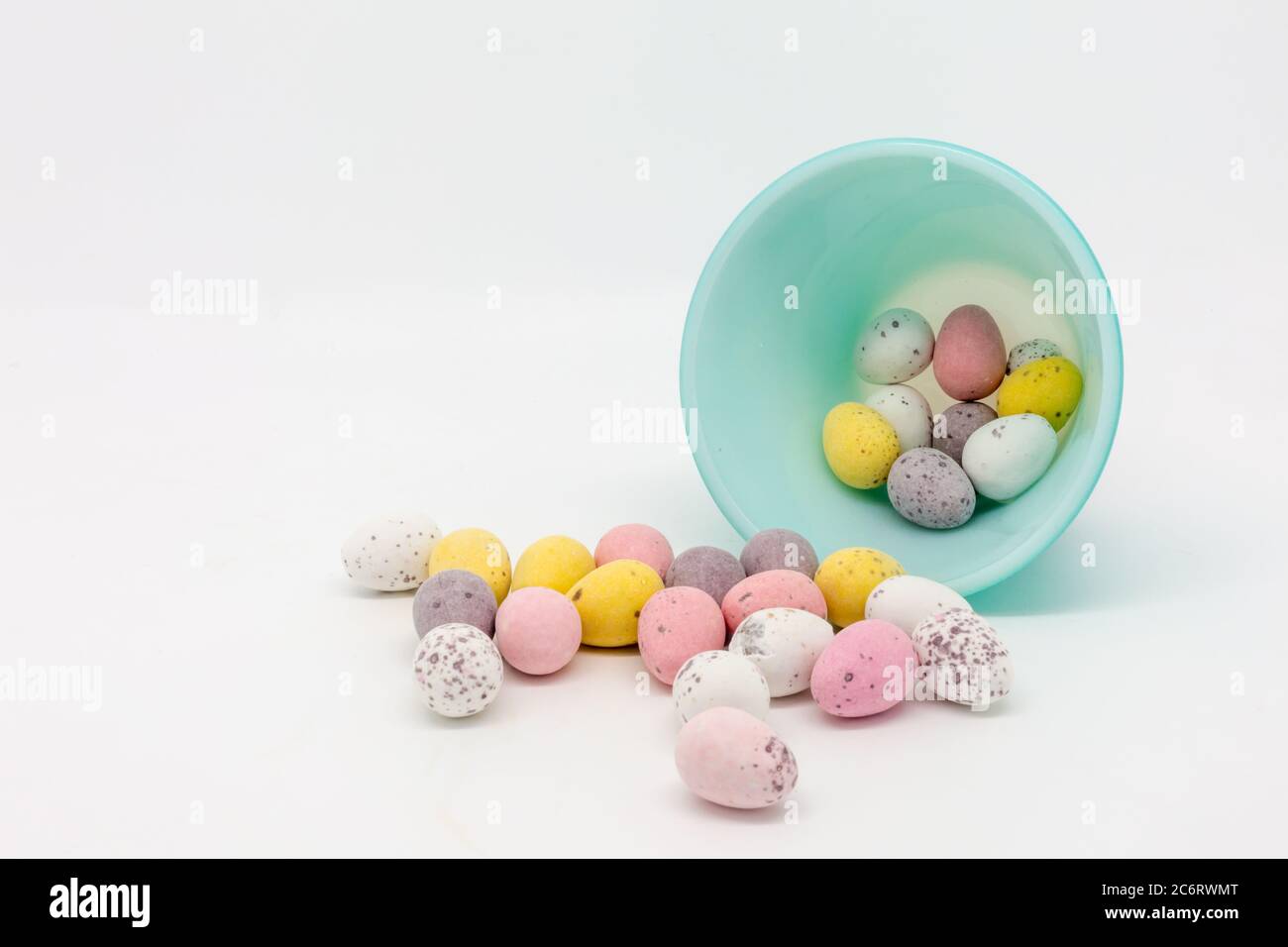 Easter eggs spilling out of a bowl, against a white background Stock ...
