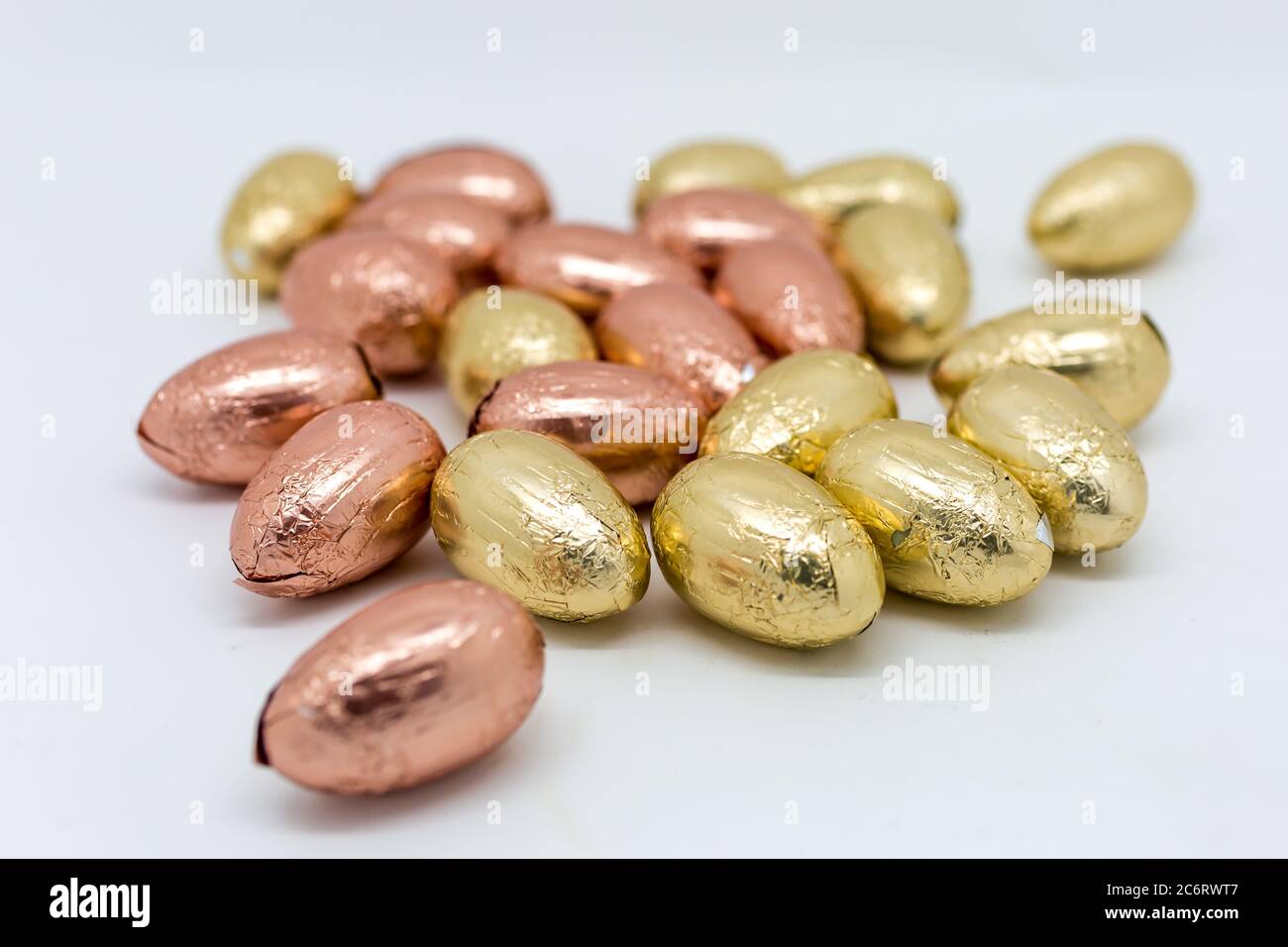 Easter eggs wrapped in foil, against a white background Stock Photo - Alamy