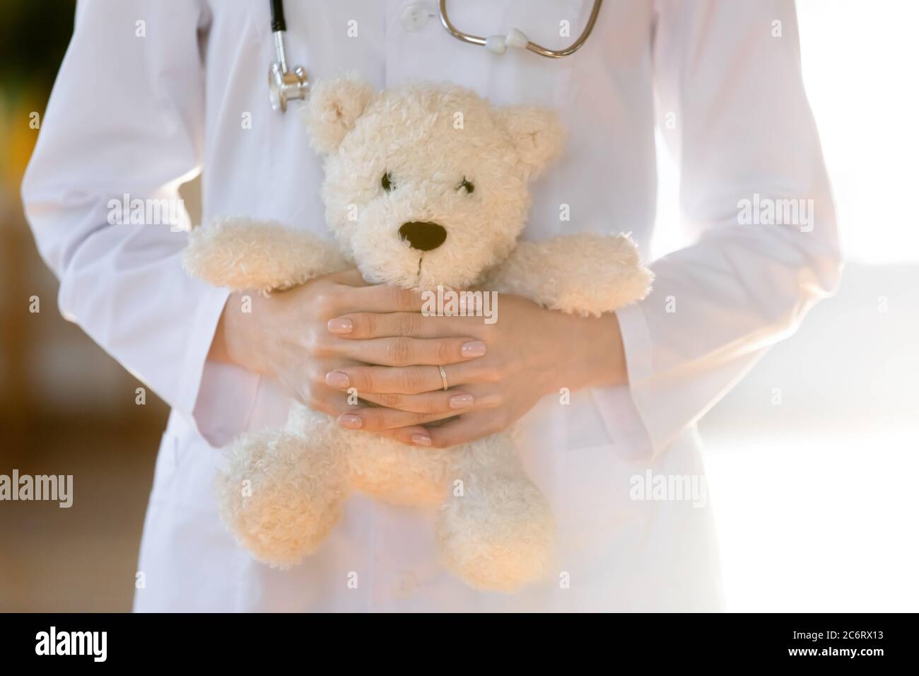 Close up female doctor holding fluffy toy, children healthcare Stock ...