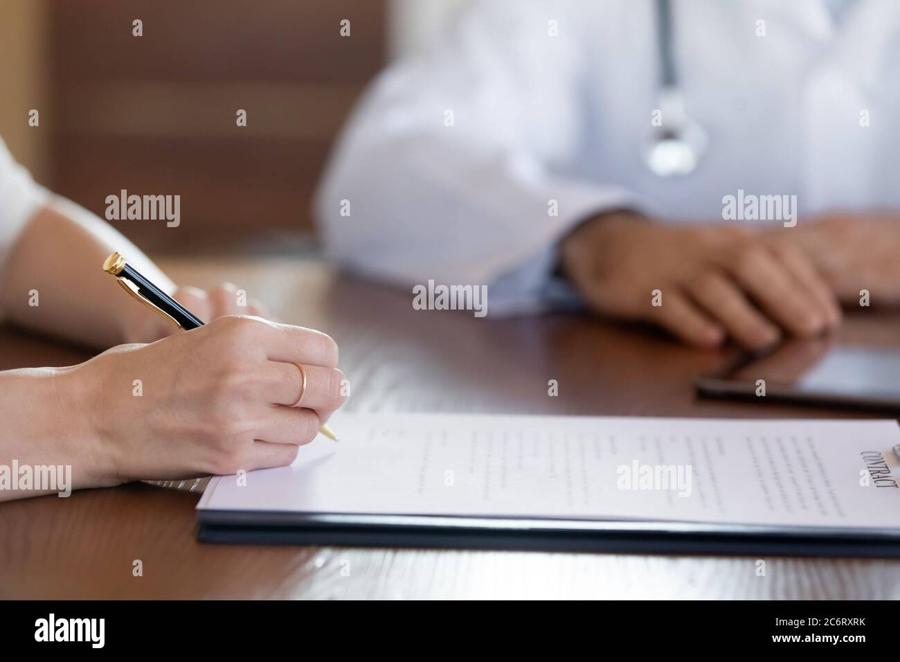 Female patient signing medical agreement hi-res stock photography and ...