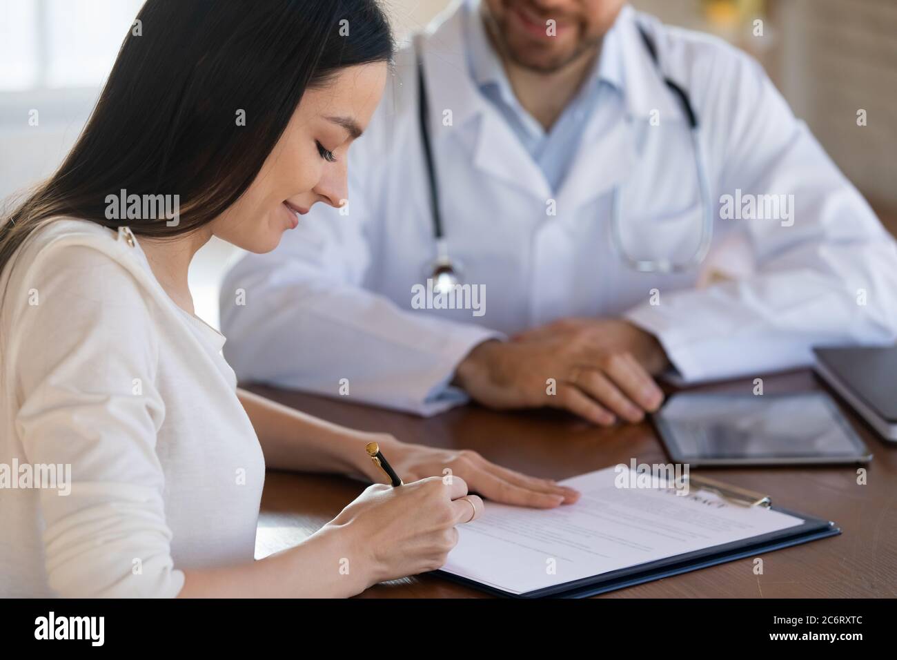 Close up female patient signing medical form, insurance contract Stock ...