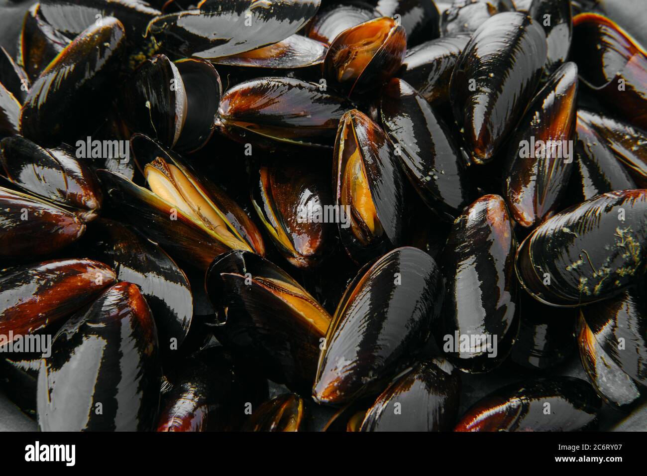 Macro photo of frozen cooked whole shell mussels Stock Photo - Alamy