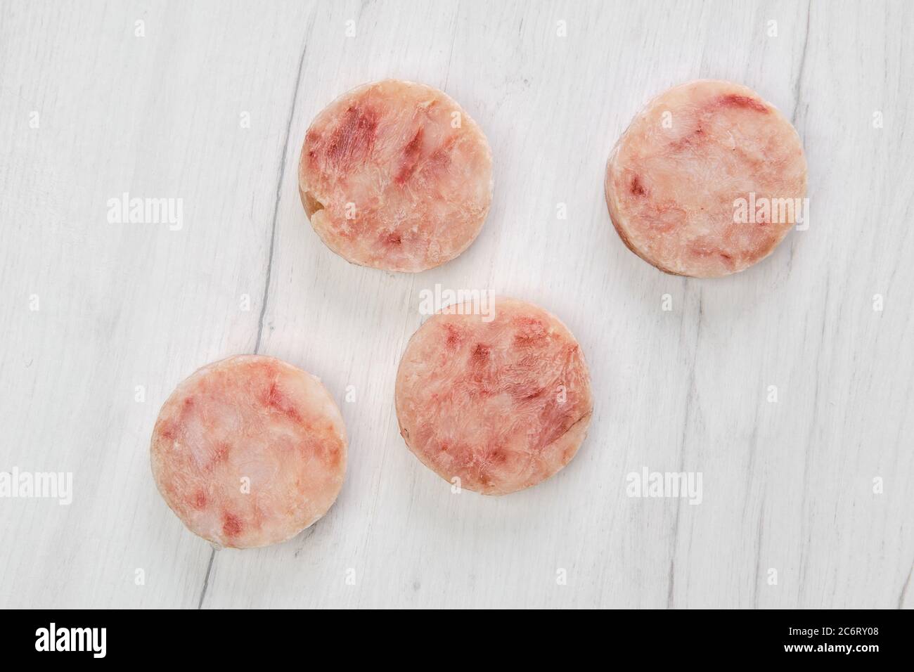 Frozen round fish cutlet for burger or frying Stock Photo - Alamy