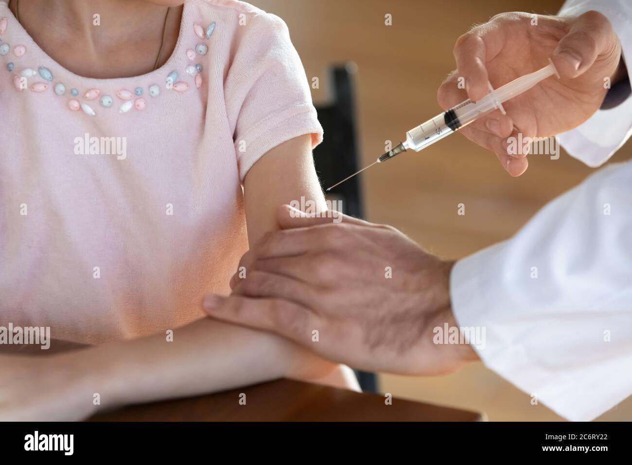 Close up doctor vaccinating little girl, holding syringe Stock Photo ...