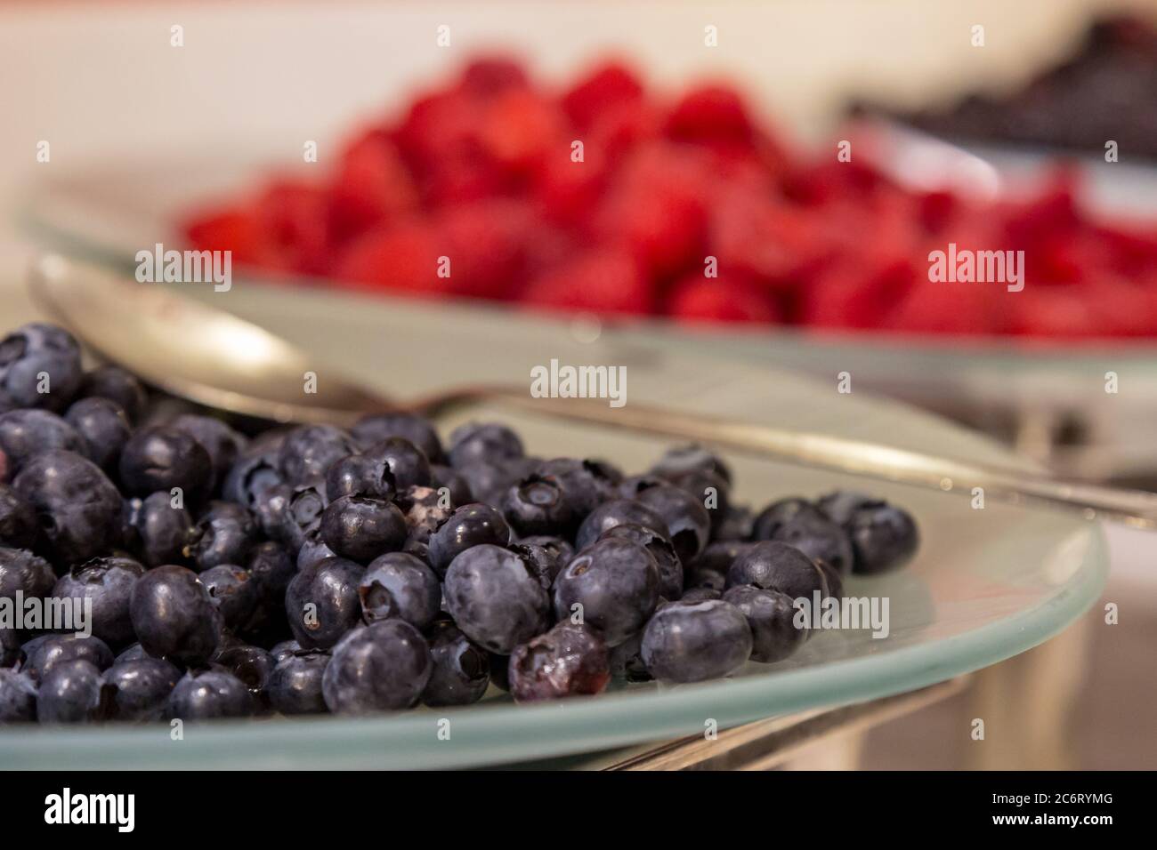 Plates of berries on a breakfast buffet Stock Photo - Alamy