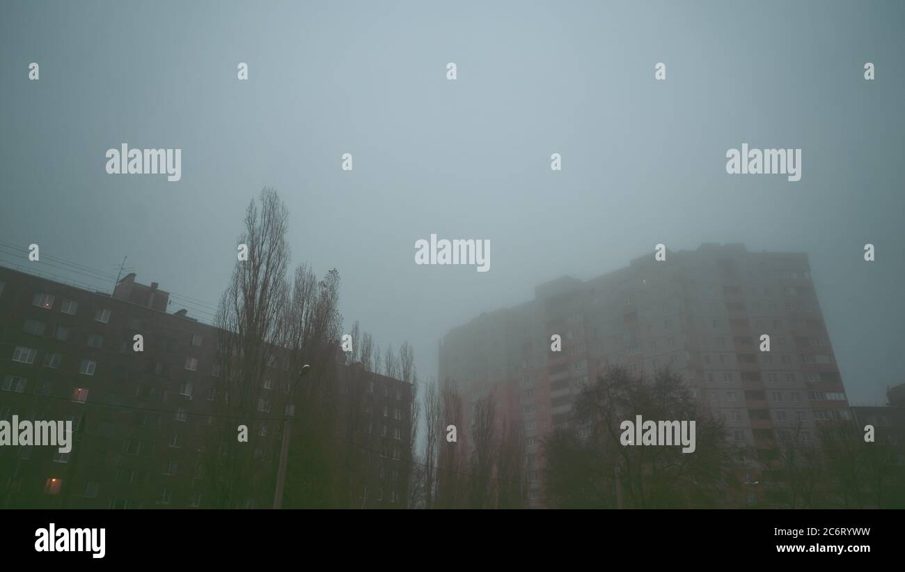 Modern apartment buildings in the morning on the background of fog. The ...