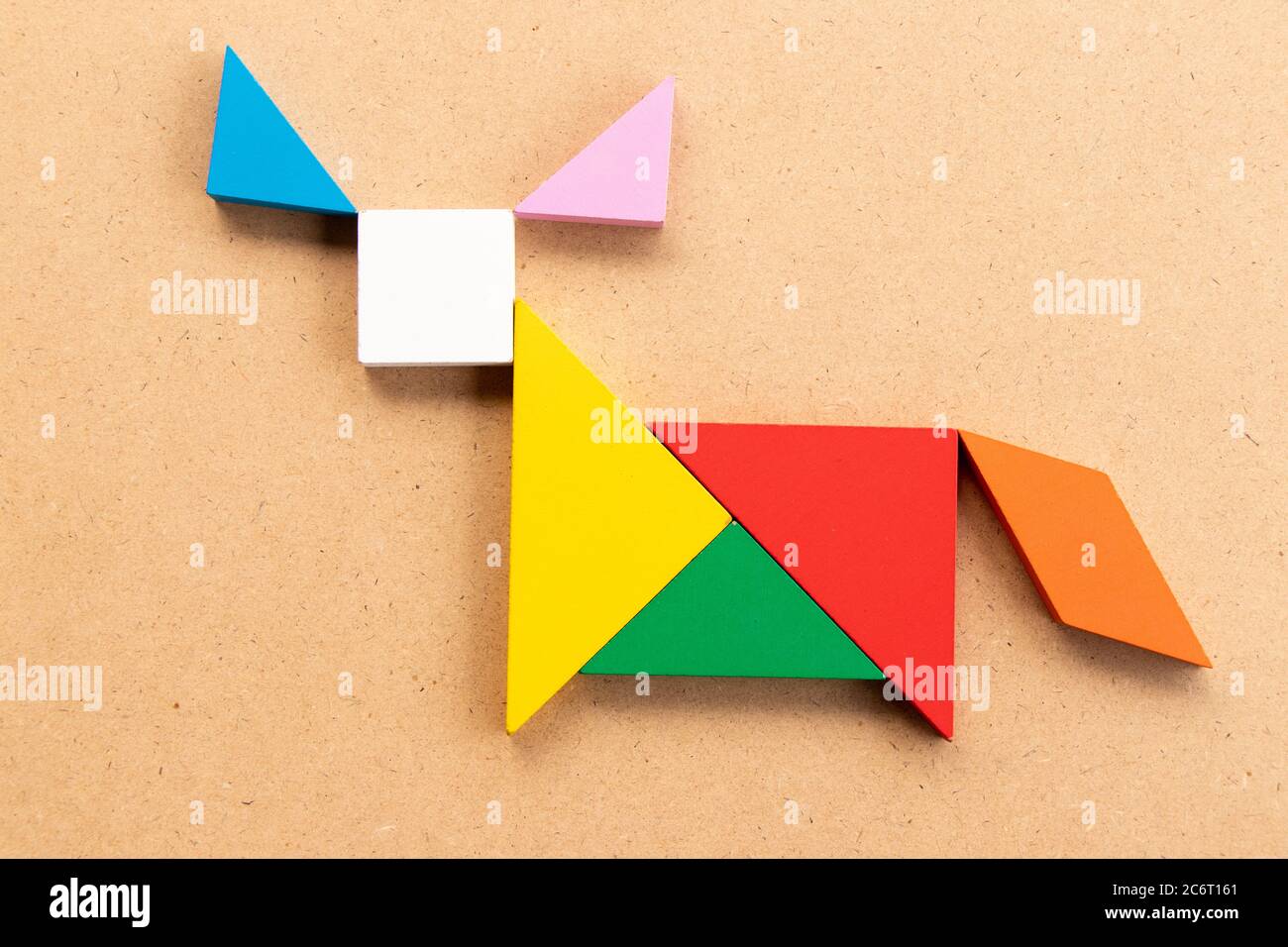 Color tangram puzzle in ox, buffalo or bull shape on wood bacground ...