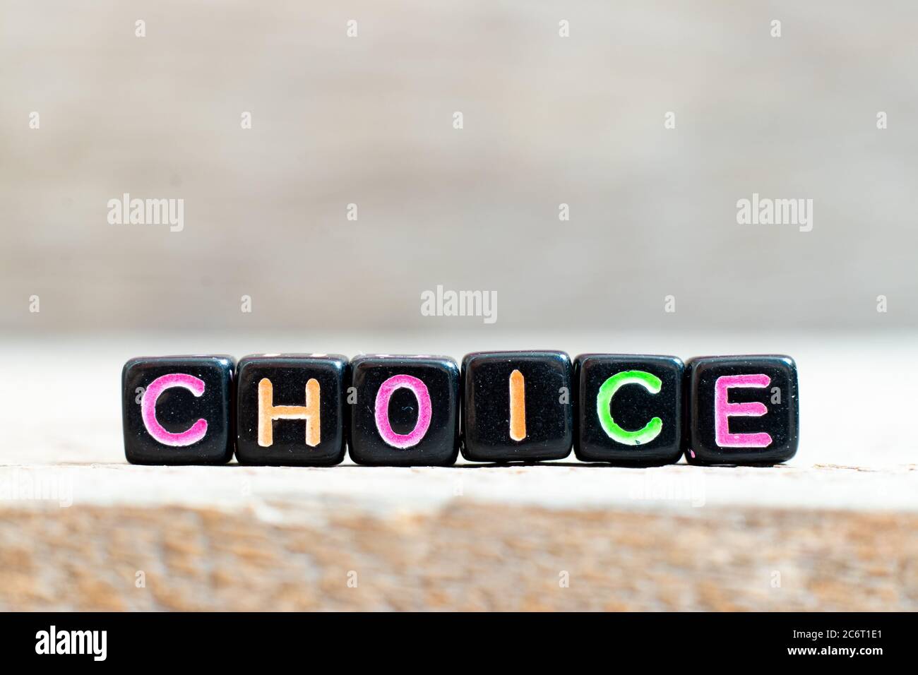 Black bead with color letter in word choice on wood background Stock ...