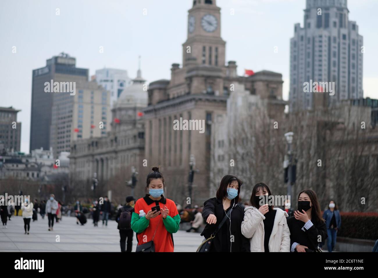 Several young girls wearing surgical masks walking at the bund in ...