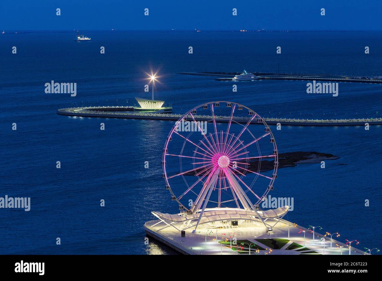 A view across Baku Bay at dusk featuring the Baku Eye or Devils wheel ...
